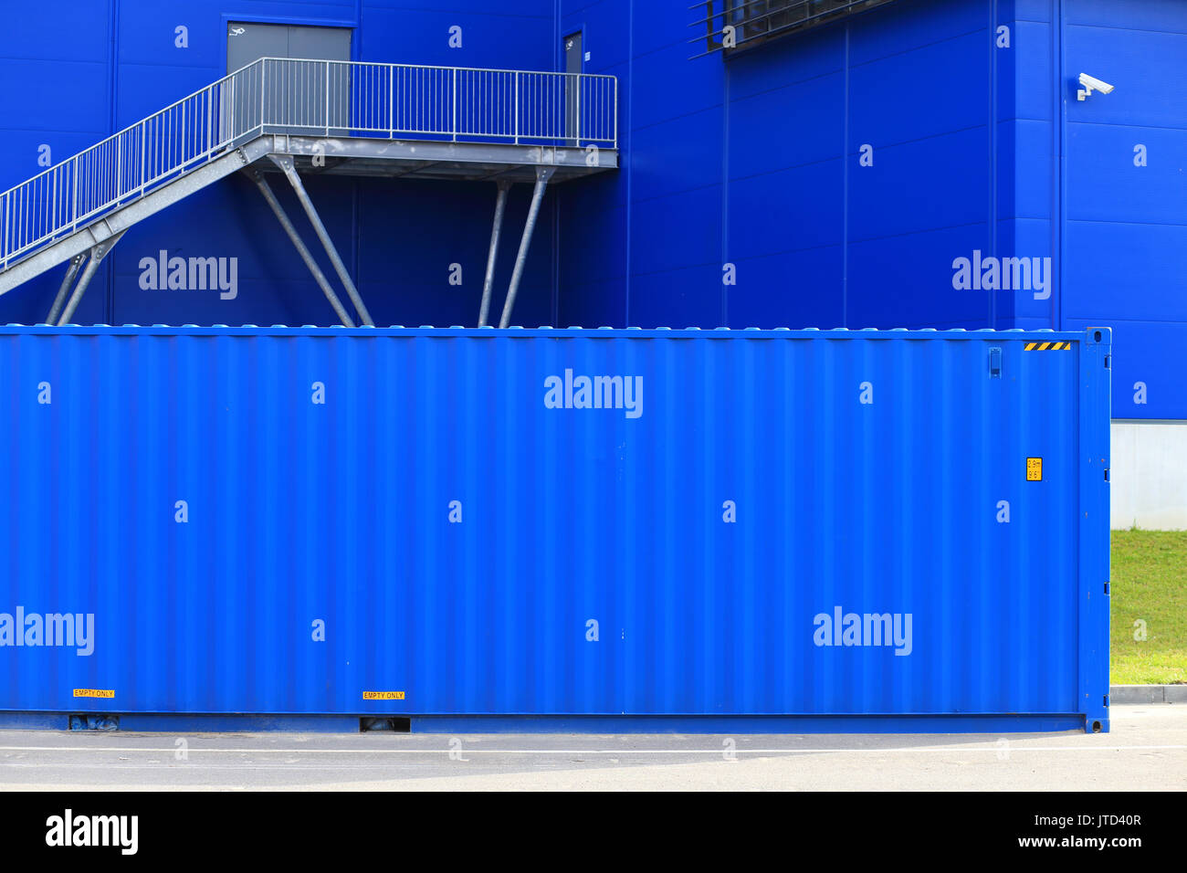 Blue cargo container on blue building background. Cargo container at ...