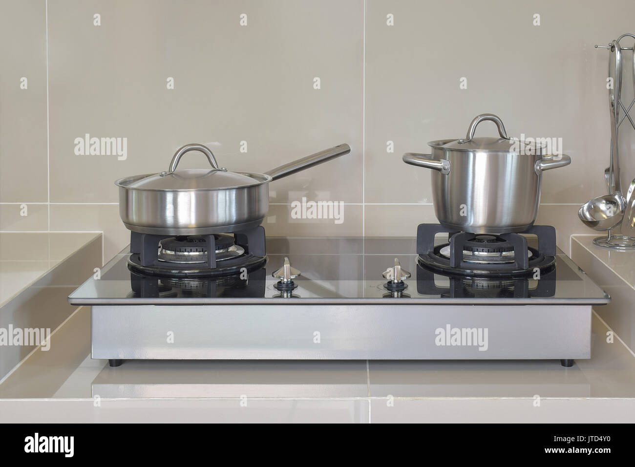 stainless pots in modern kitchen Stock Photo - Alamy