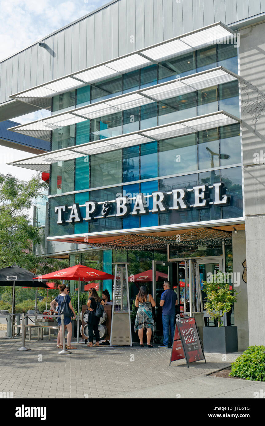 People waiting outside the entrance to Tap and Barrel restaurant in the ...