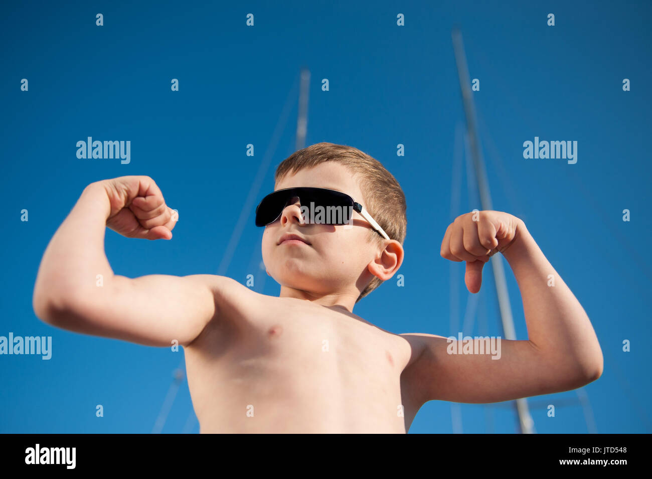 strong little kid showing his muscle Stock Photo - Alamy