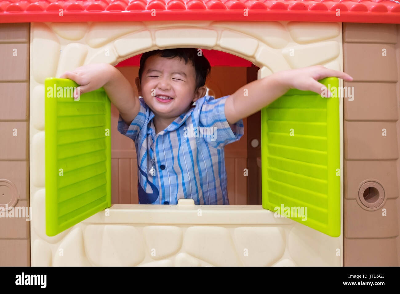 Happy Asian child Boy playing with window toy house in playground Stock ...