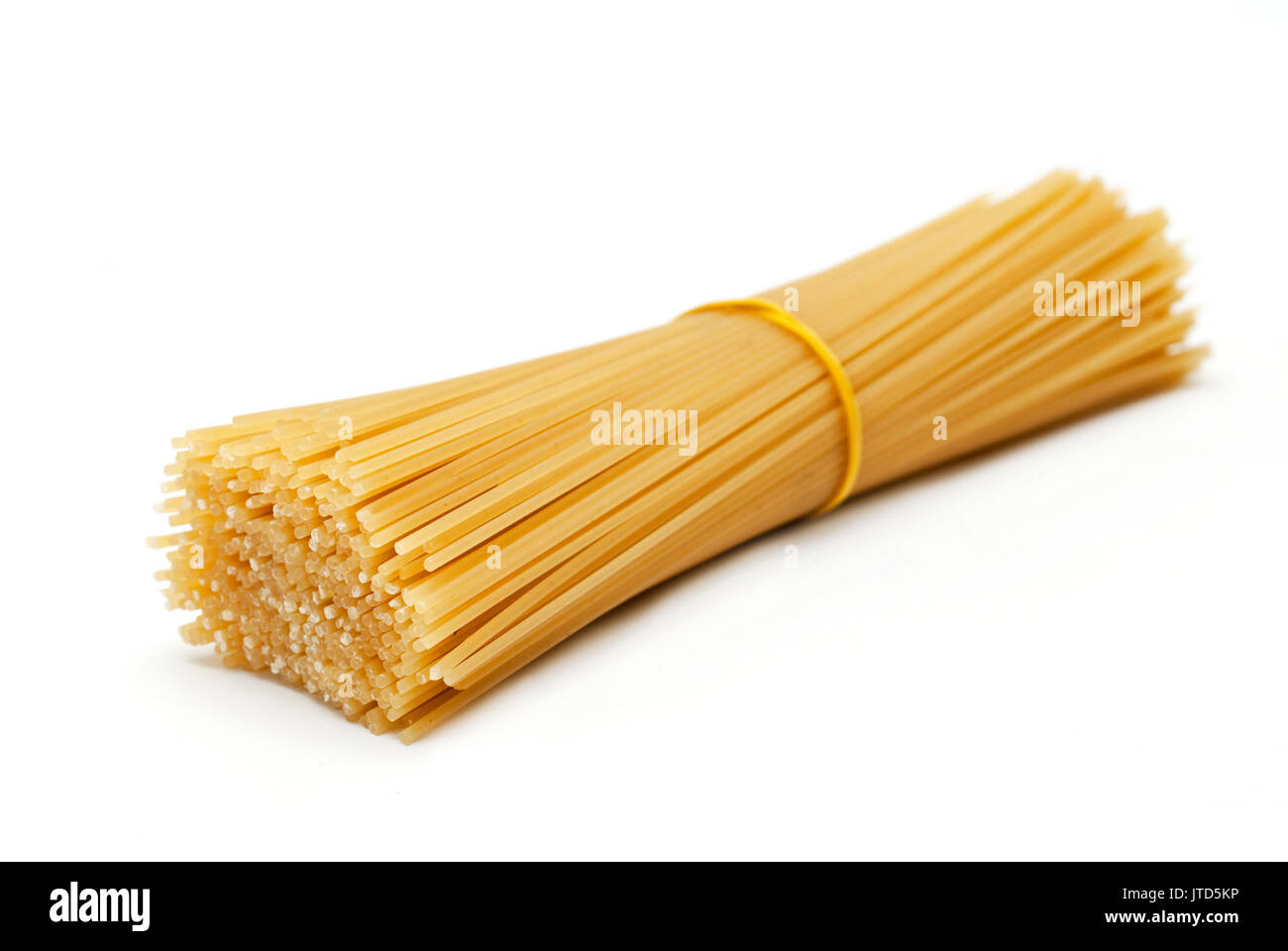 Spaghetti gathered into a bundle on a white background Stock Photo - Alamy