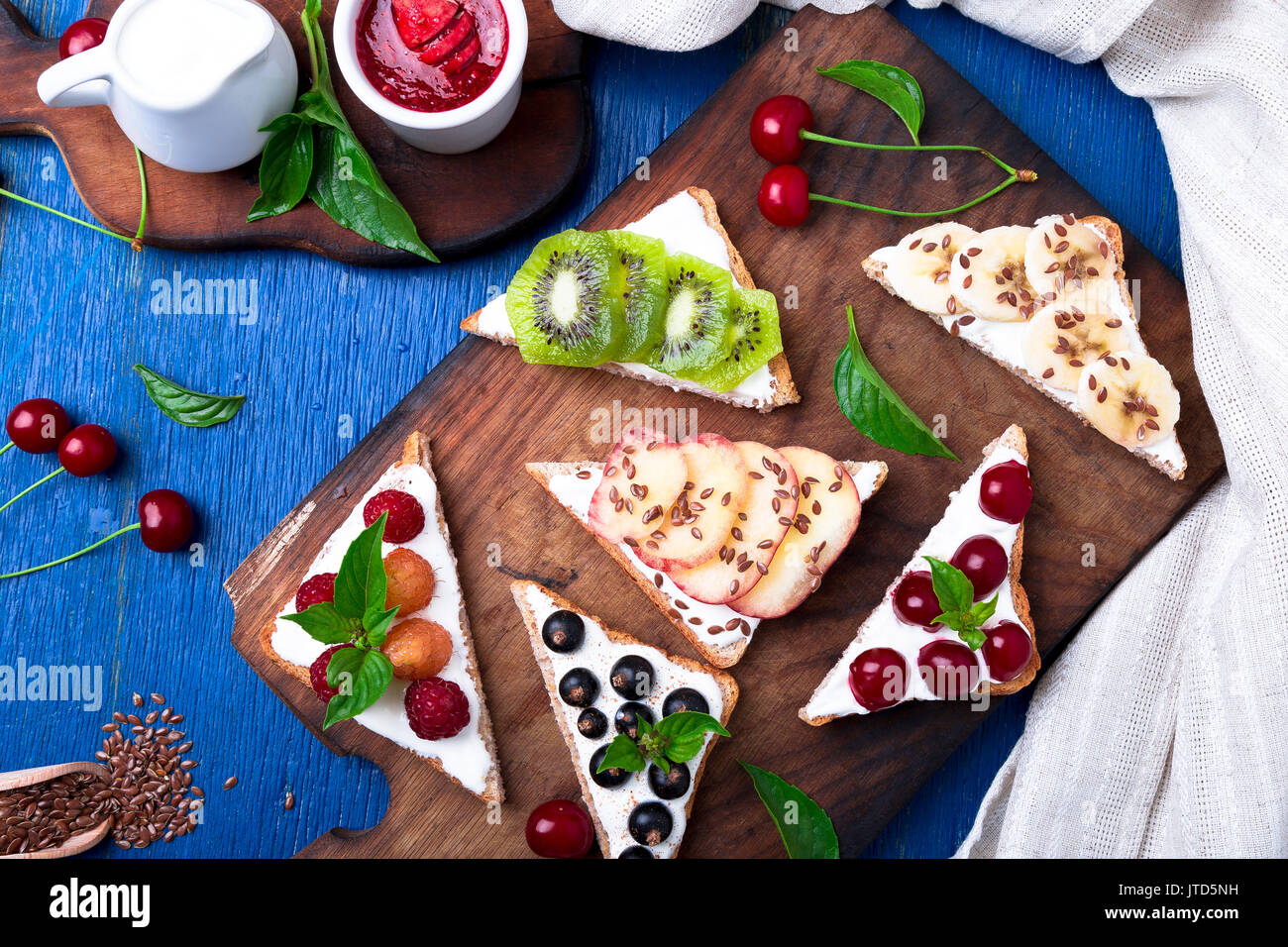 Fruit toast on wooden board on blue rustic background. Healthy ...