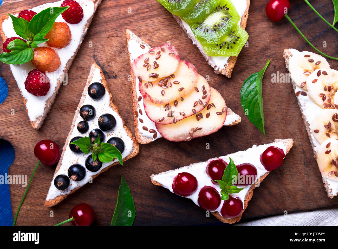 Fruit toast on wooden board on blue rustic background. Healthy ...