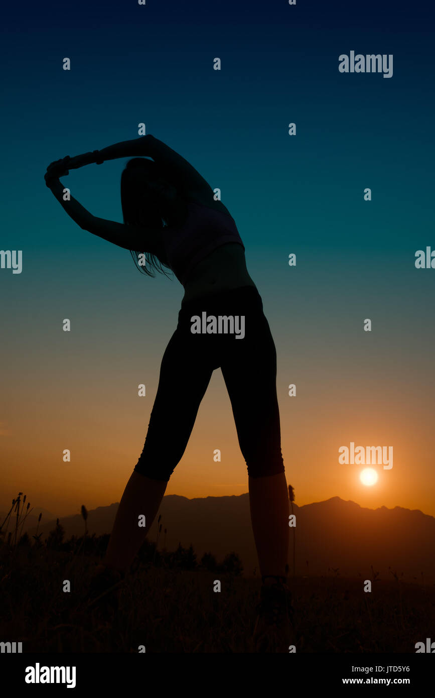 Practicing gymnast girl at sunset towards the sun Stock Photo - Alamy