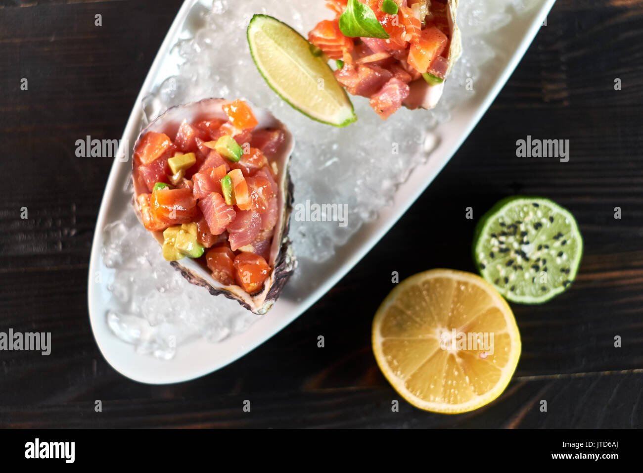 Delicious red fish in the shells of shellfish. With lemon and lime jpg ...