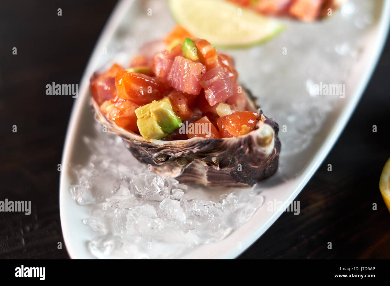 Delicious red fish in the shells of shellfish. With lemon and lime jpg ...