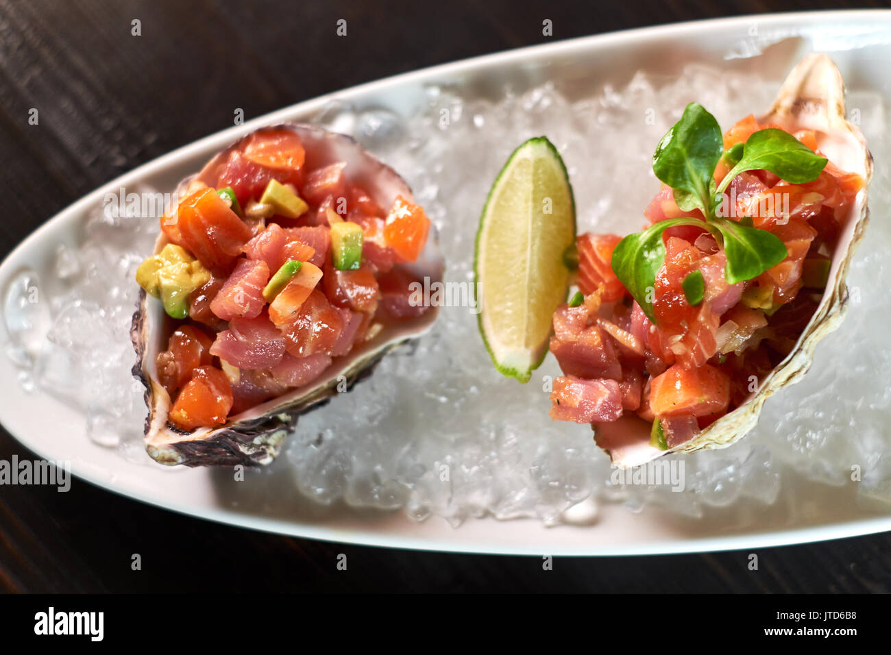 Delicious red fish in the shells of shellfish. With lemon and lime jpg ...