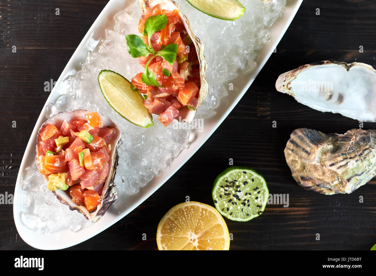 Delicious red fish in the shells of shellfish. With lemon and lime jpg ...