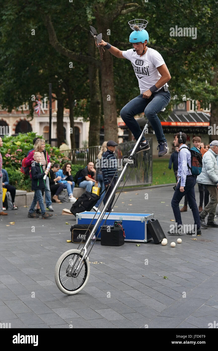 A juggling unicyclist dismounts from his cycle in Leicester Square in ...