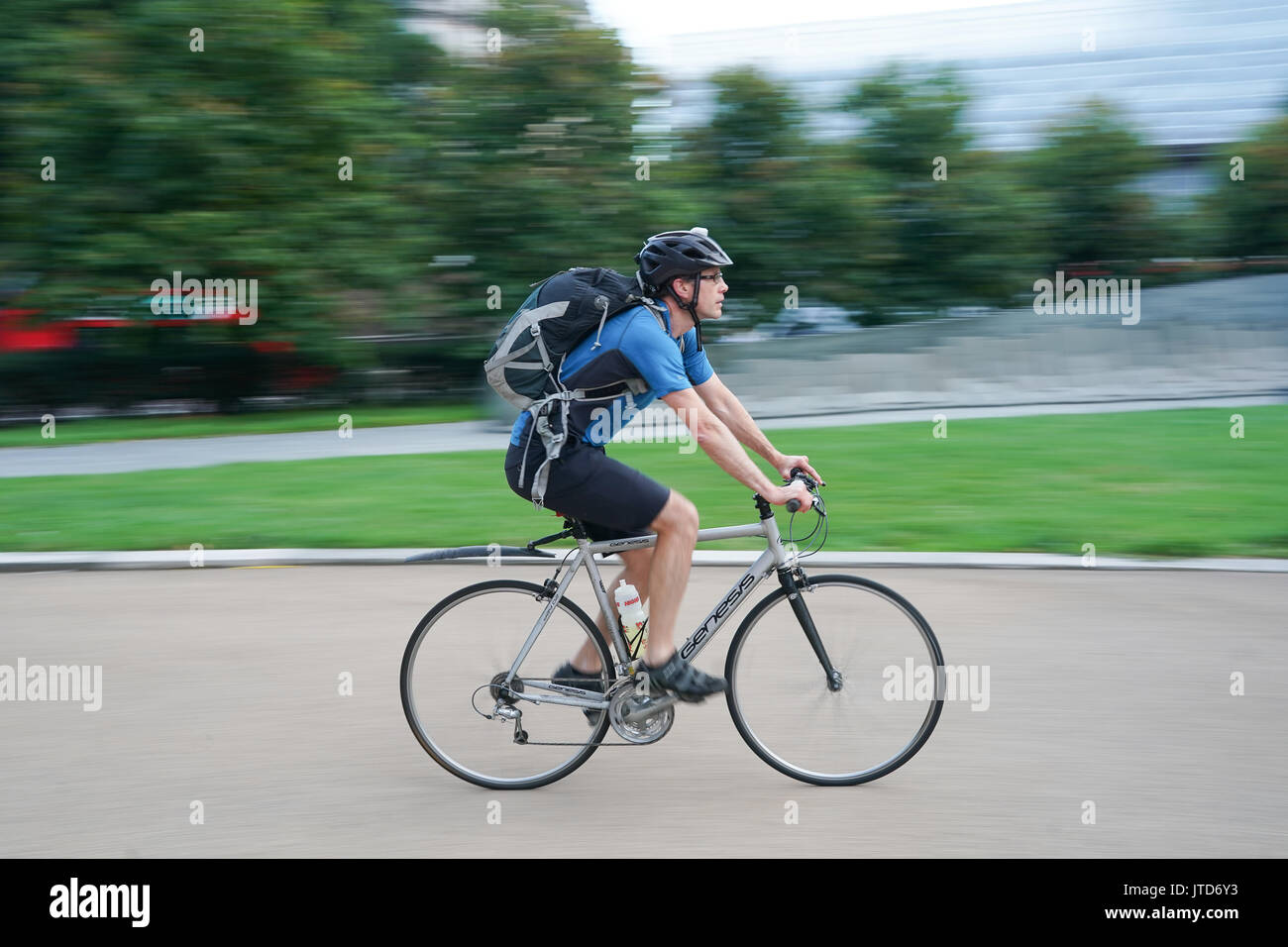 A view of a cyclist riding a bike in Hyde Park Corner in London, UK ...