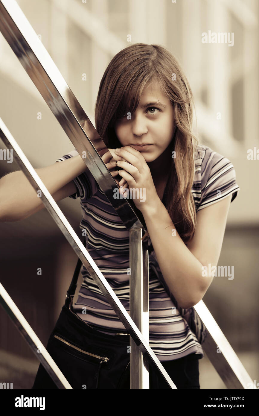 Sad teen girl against a school building Stock Photo - Alamy