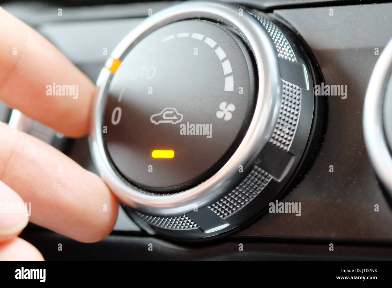 hand on air positioner control in car dashboard. Car air conditioning ...