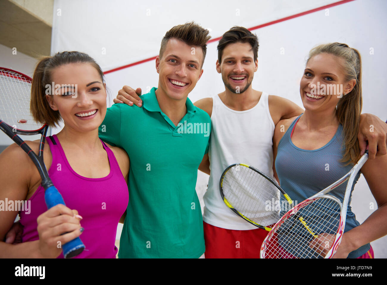 Team of friends on court for squash Stock Photo - Alamy