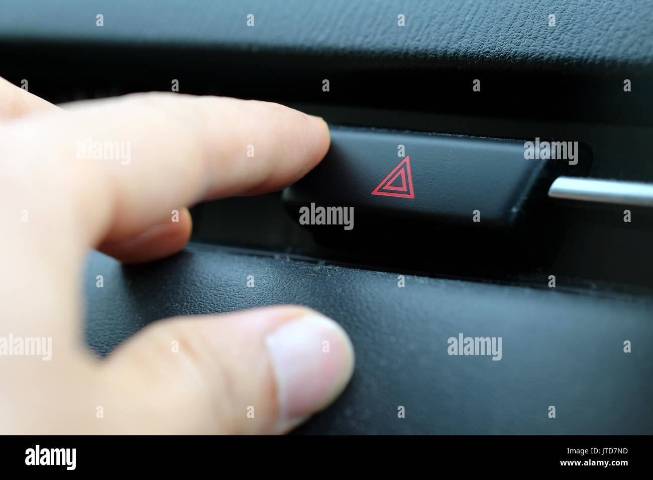 pressing emergency button on Car Dashboard Stock Photo - Alamy
