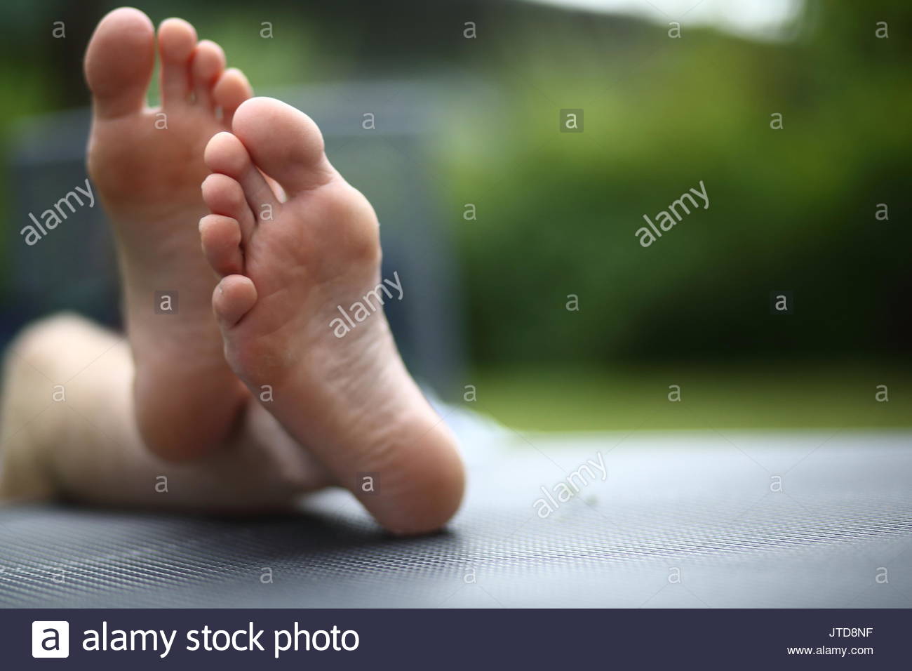 Bare feet resting on a table on a relaxing afternoon Stock Photo - Alamy
