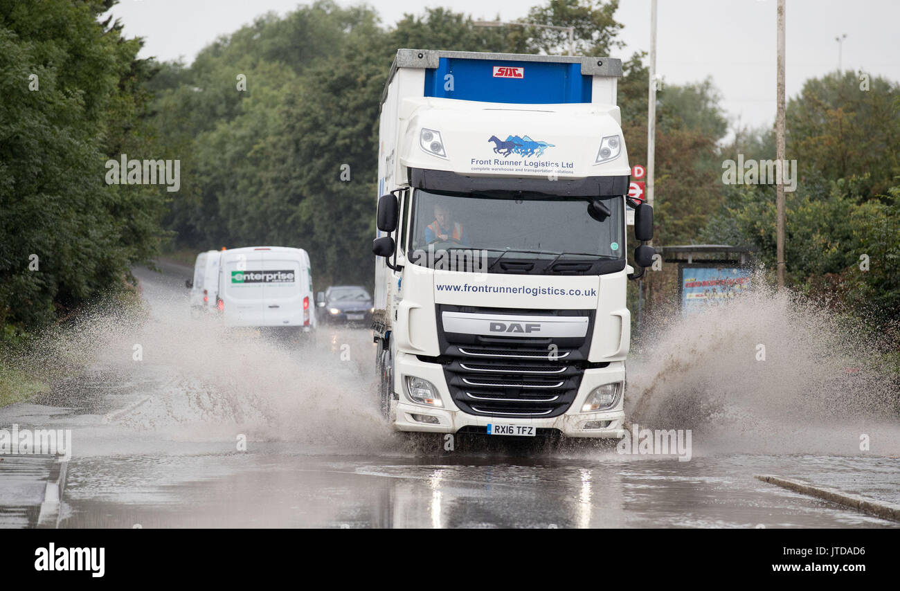 A lorry goes through a large puddle near Colnbrook, Berkshire as a ...