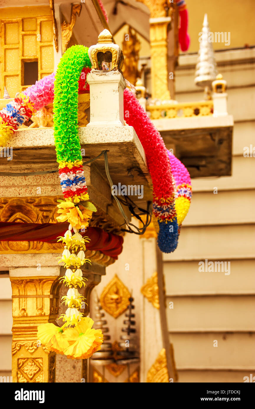 Colorful plastic flower garland on Traditional Thai outdoor spirit ...