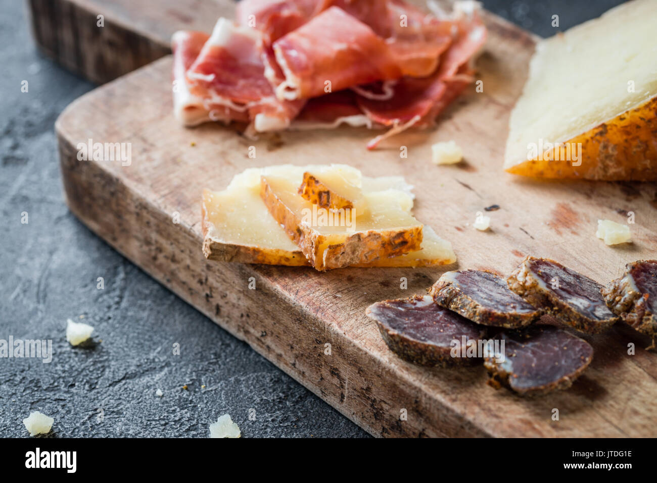 Platter with homemade dried meat salami, sliced Italian hard cheese ...