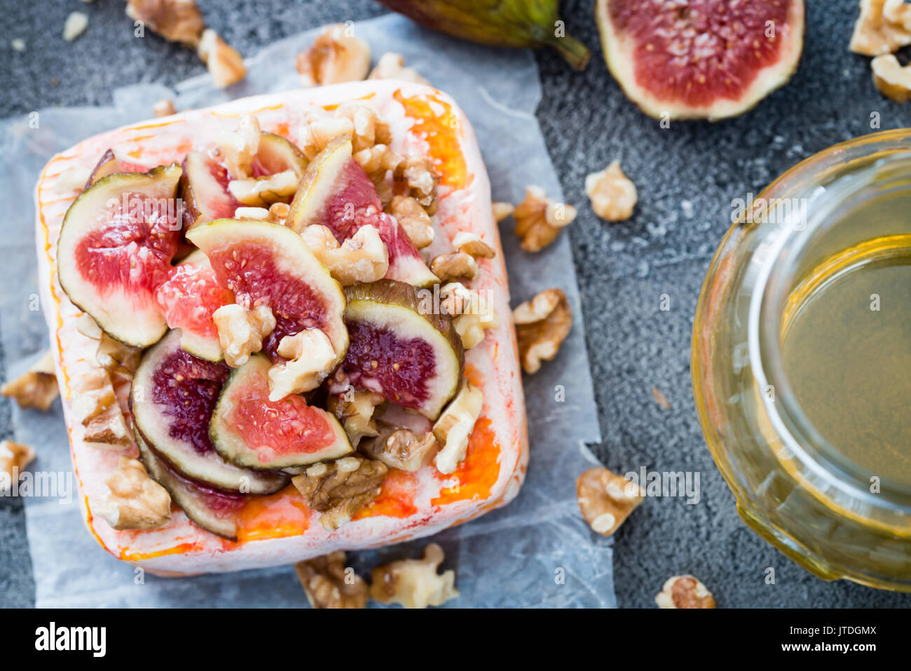 Raw French soft cheese from Brittany region covered with chopped figs ...