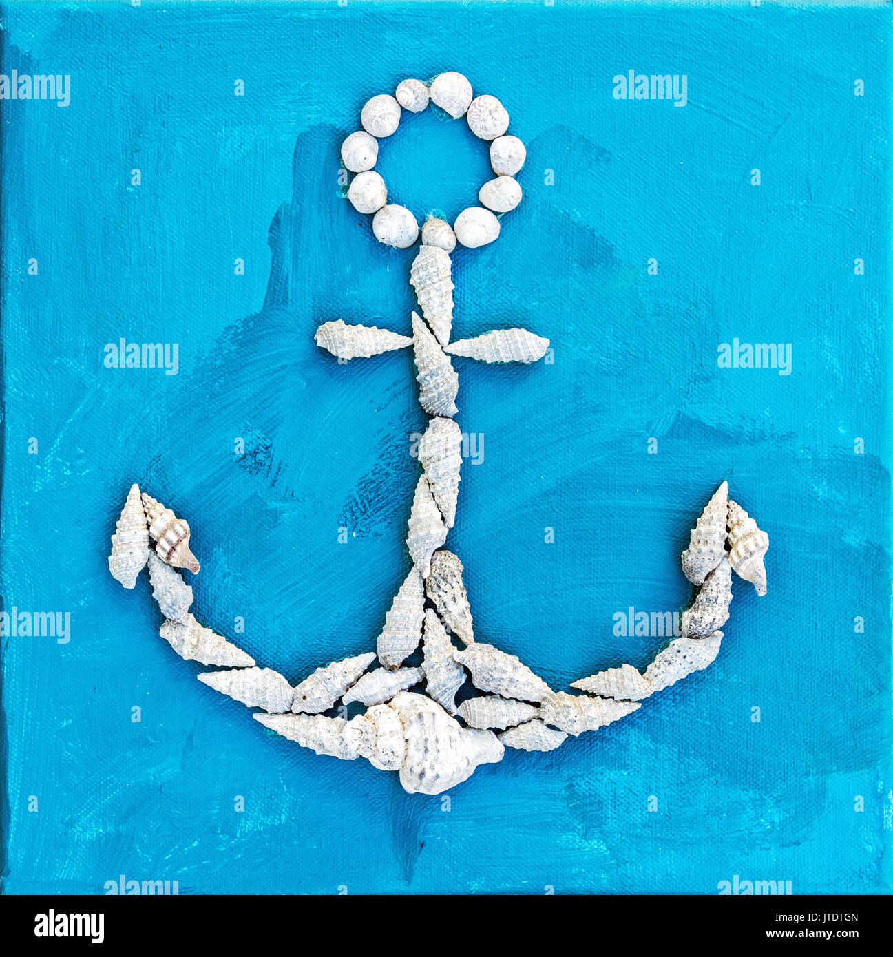 Marine anchor made of seashells on the blue background. Summer vacation ...