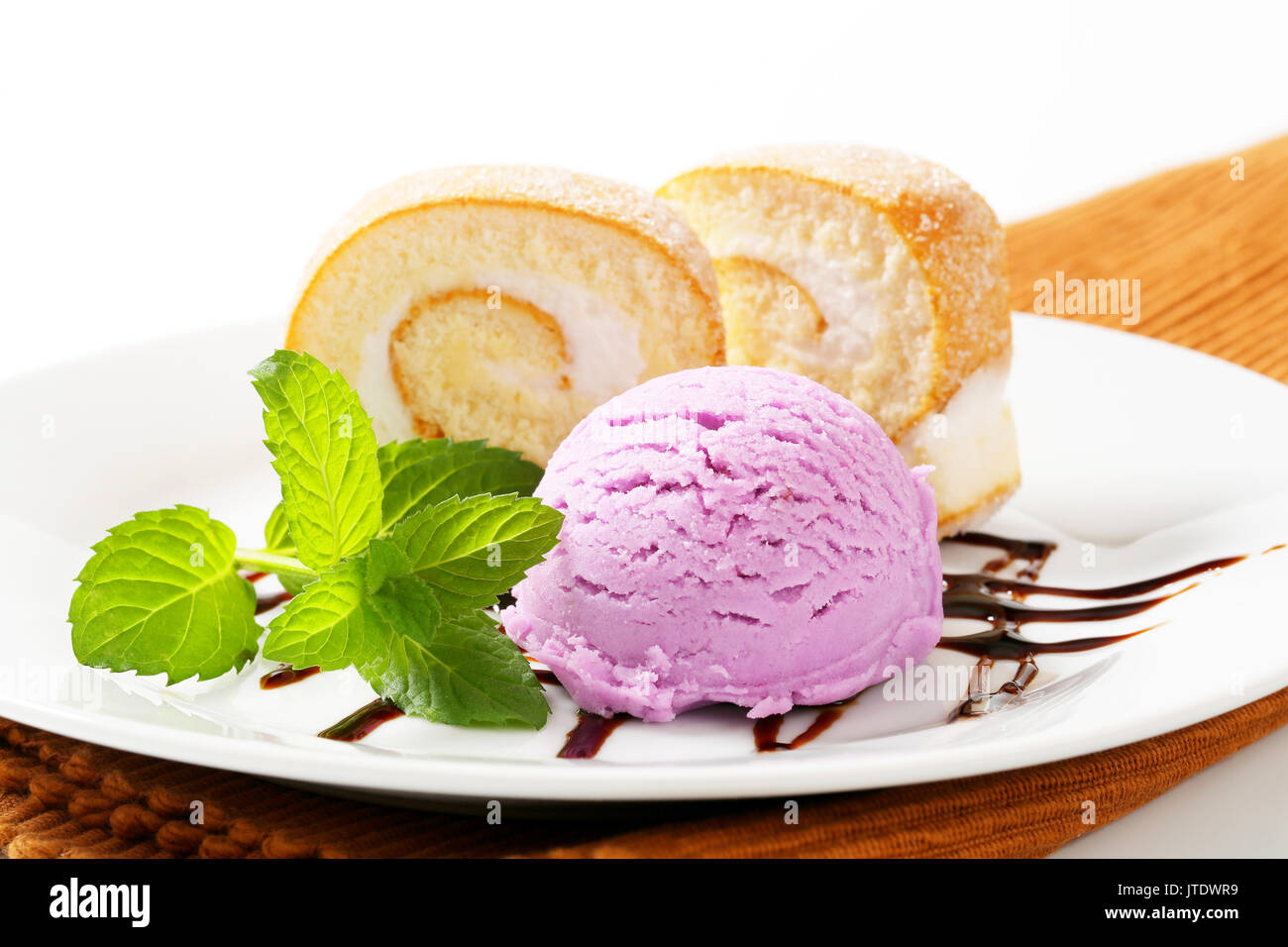 Slices of sponge cake roll with blueberry ice cream Stock Photo - Alamy