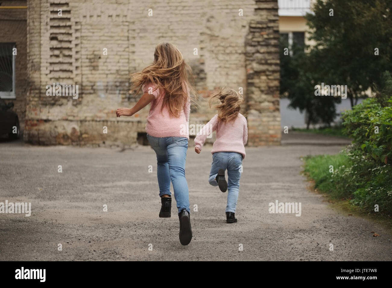 photo of two girls with long hair running away Stock Photo - Alamy