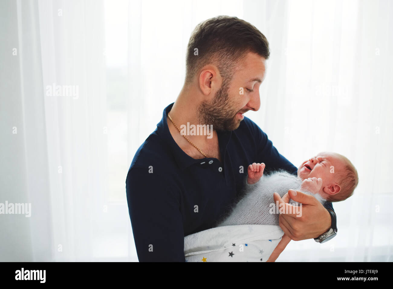 Father comforting crying child hi-res stock photography and images - Alamy