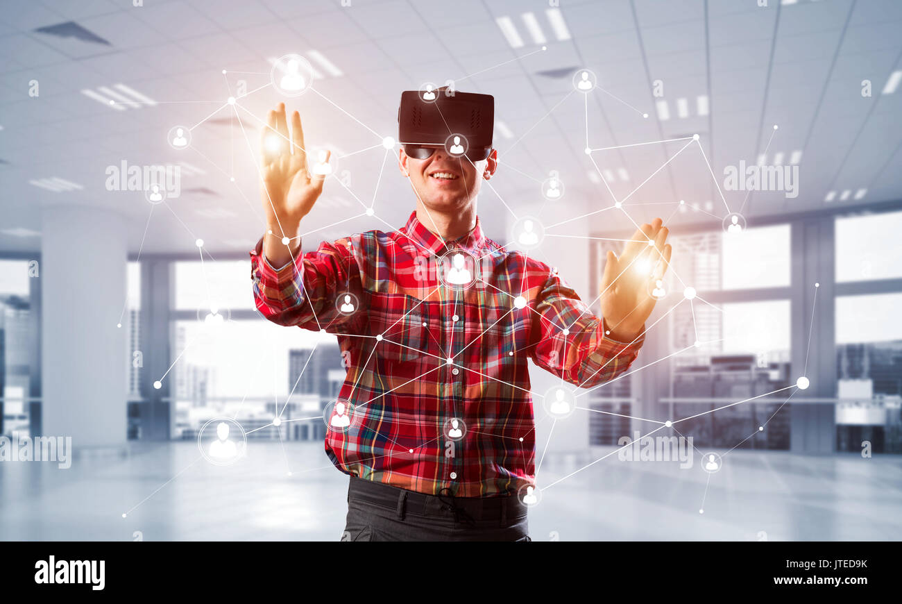 Guy wearing checked shirt and virtual mask reaching hand to touch ...