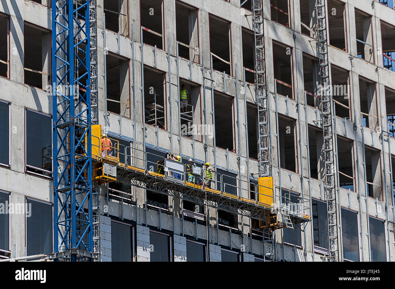 Construction workers on scaffolding. Workers on a platform Stock Photo ...
