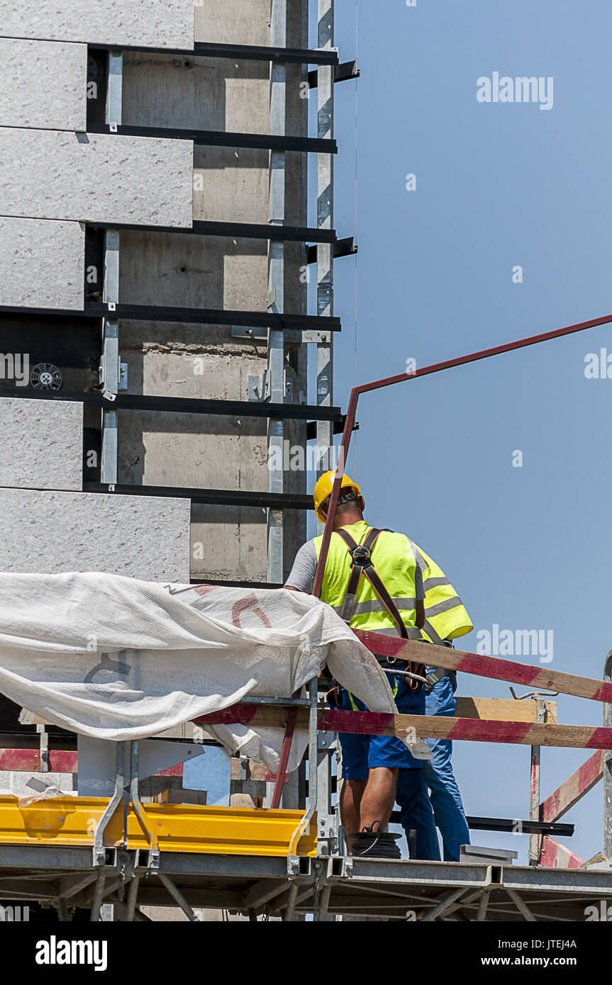 Construction workers on scaffolding. Workers on a platform Stock Photo ...