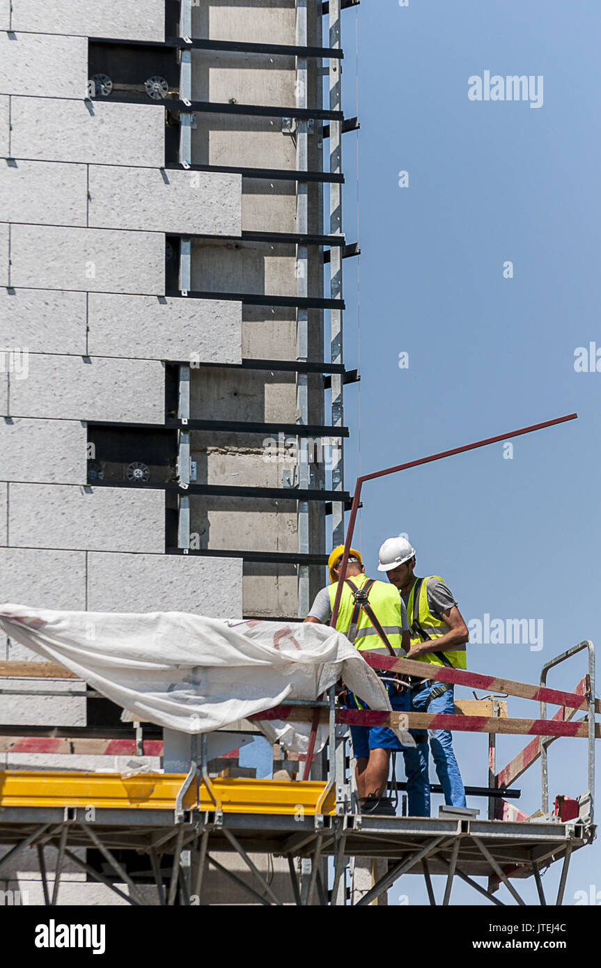 Construction workers on scaffolding. Workers on a platform Stock Photo ...
