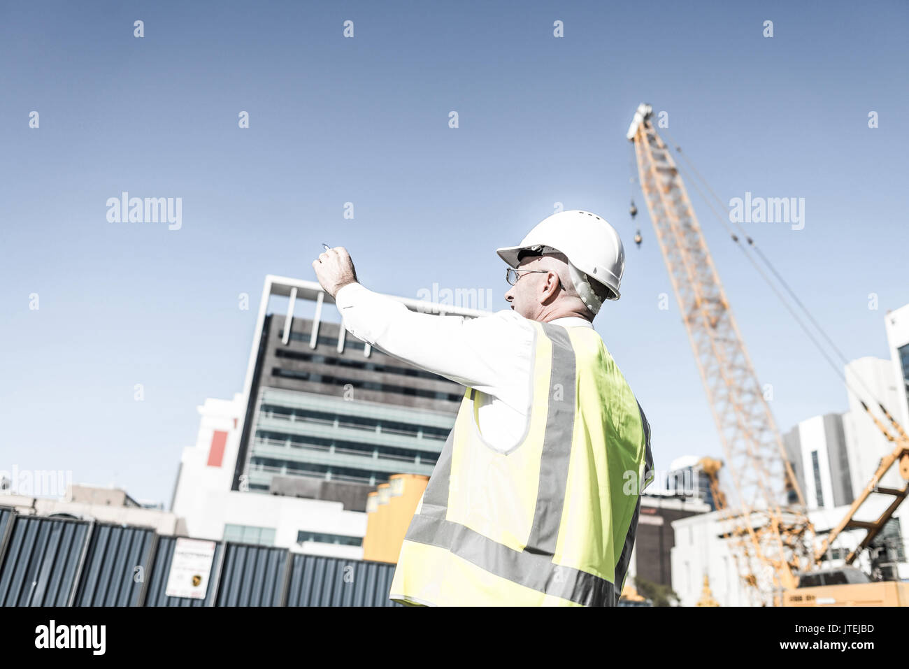 Senior foreman in glasses doing his job at building area on sunn Stock ...