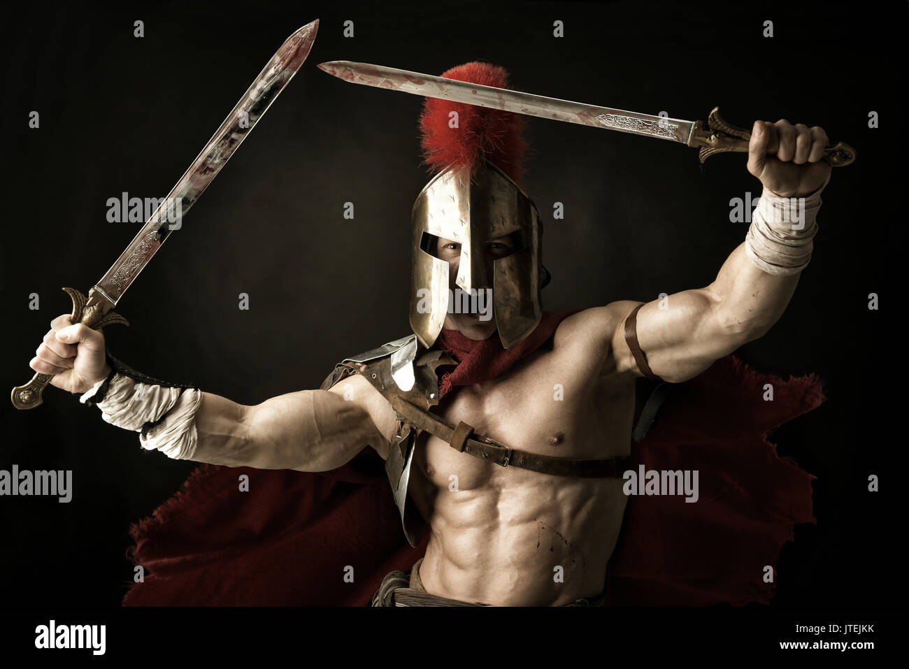 Ancient warrior or Gladiator posing over a dark background Stock Photo ...