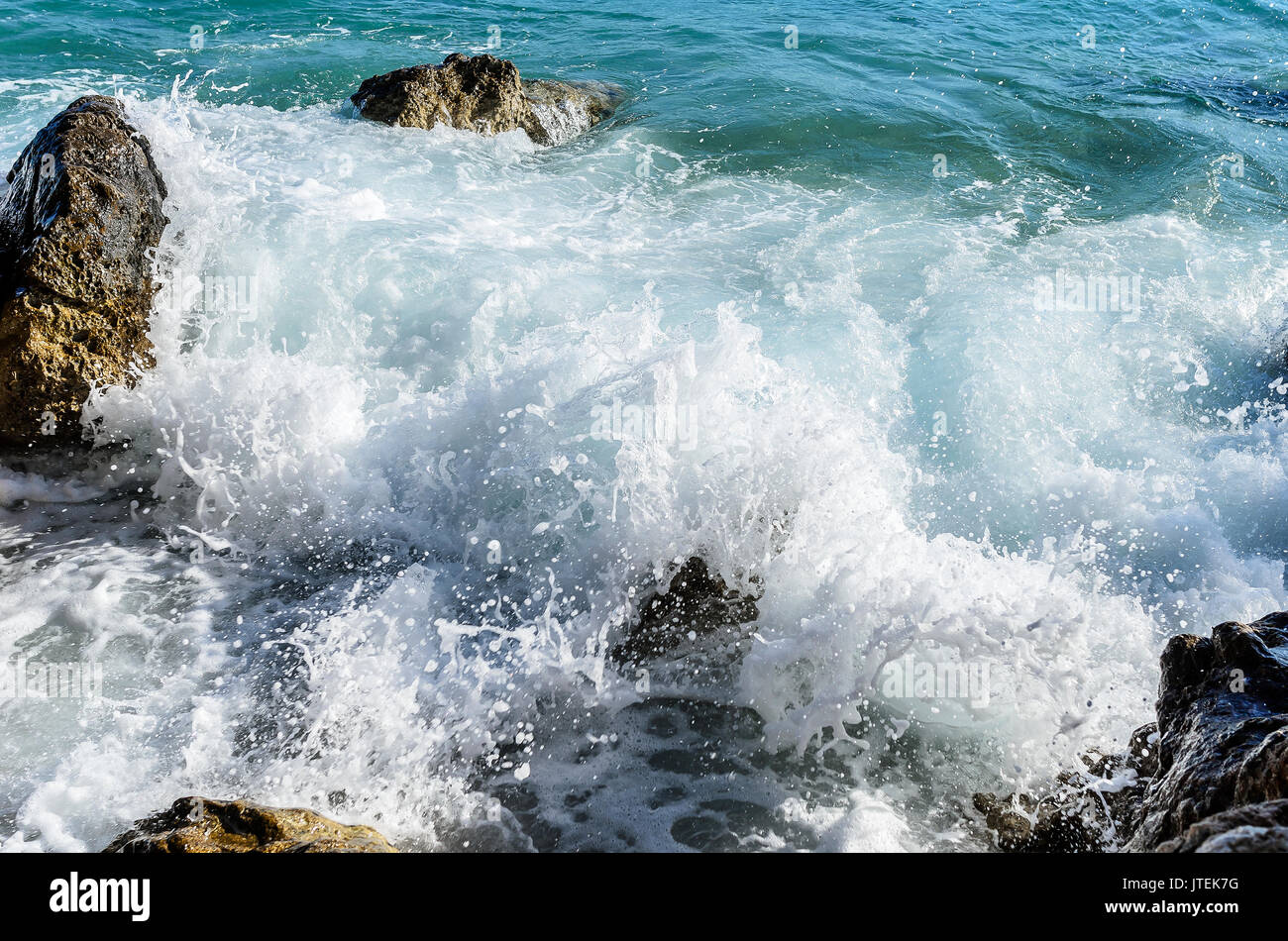 Sea wave is broken about stones Stock Photo - Alamy