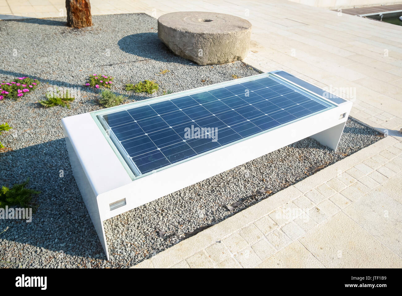 Bench with solar panel and mobile phone charger at the waterfront in ...