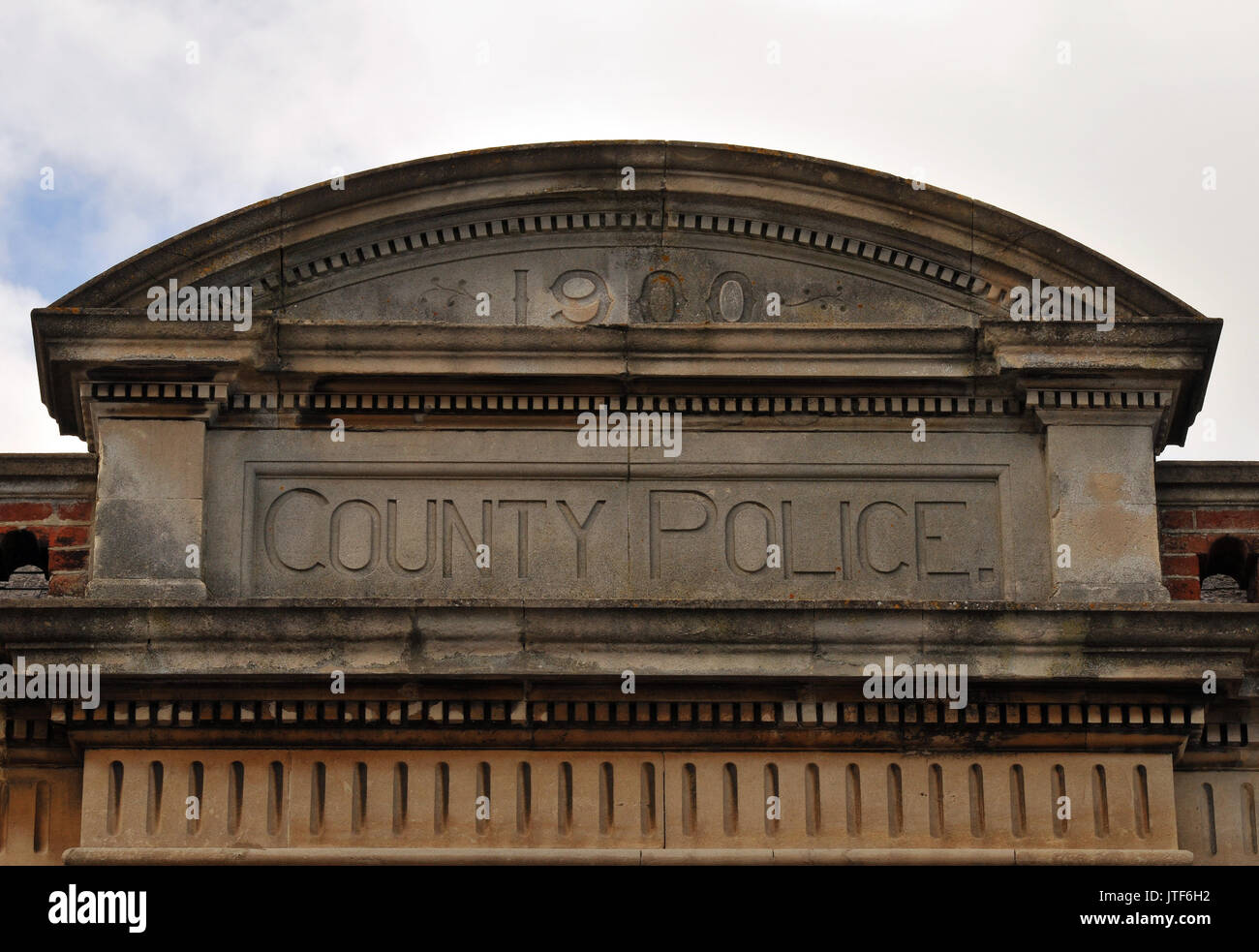an old architectural stone set above the door of a turn of the century ...