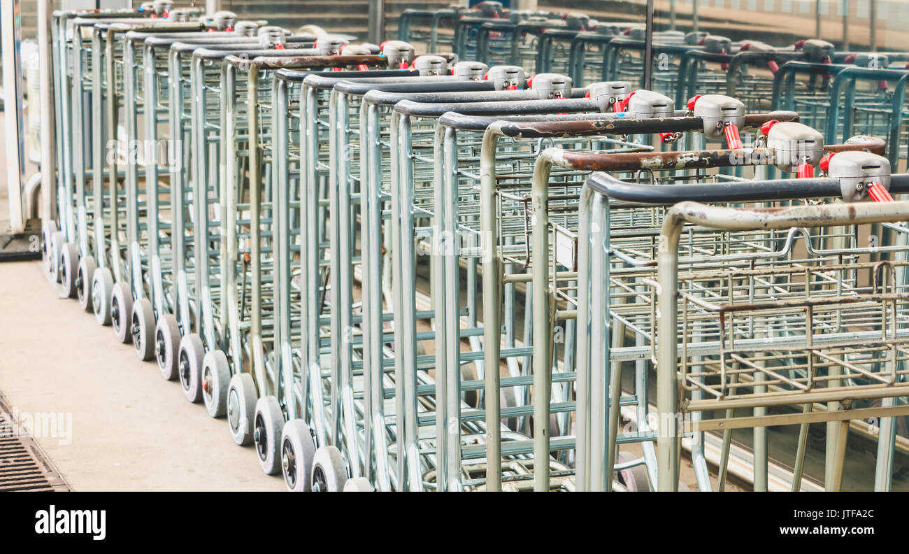 old rusty trolley luggage online in an airport Stock Photo - Alamy