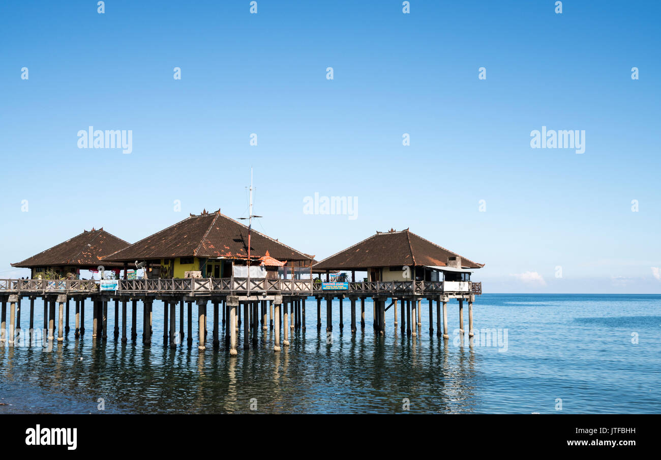 Traditional Balinese stilt houses in the sea at the old harbor ...