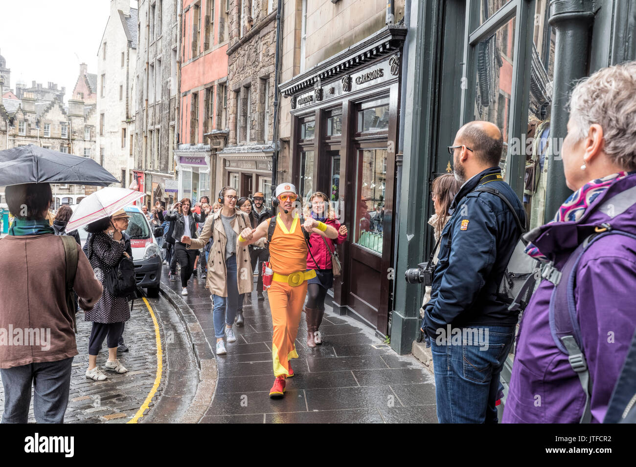 Man leads walking disco at Edinburgh Festival Stock Photo - Alamy