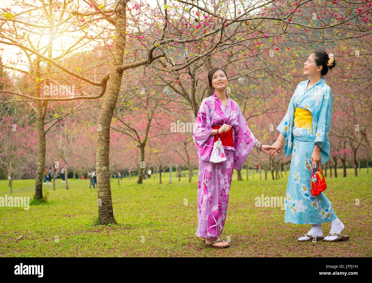 happy japanese girlfriends holding hands joyful cheerful together ...