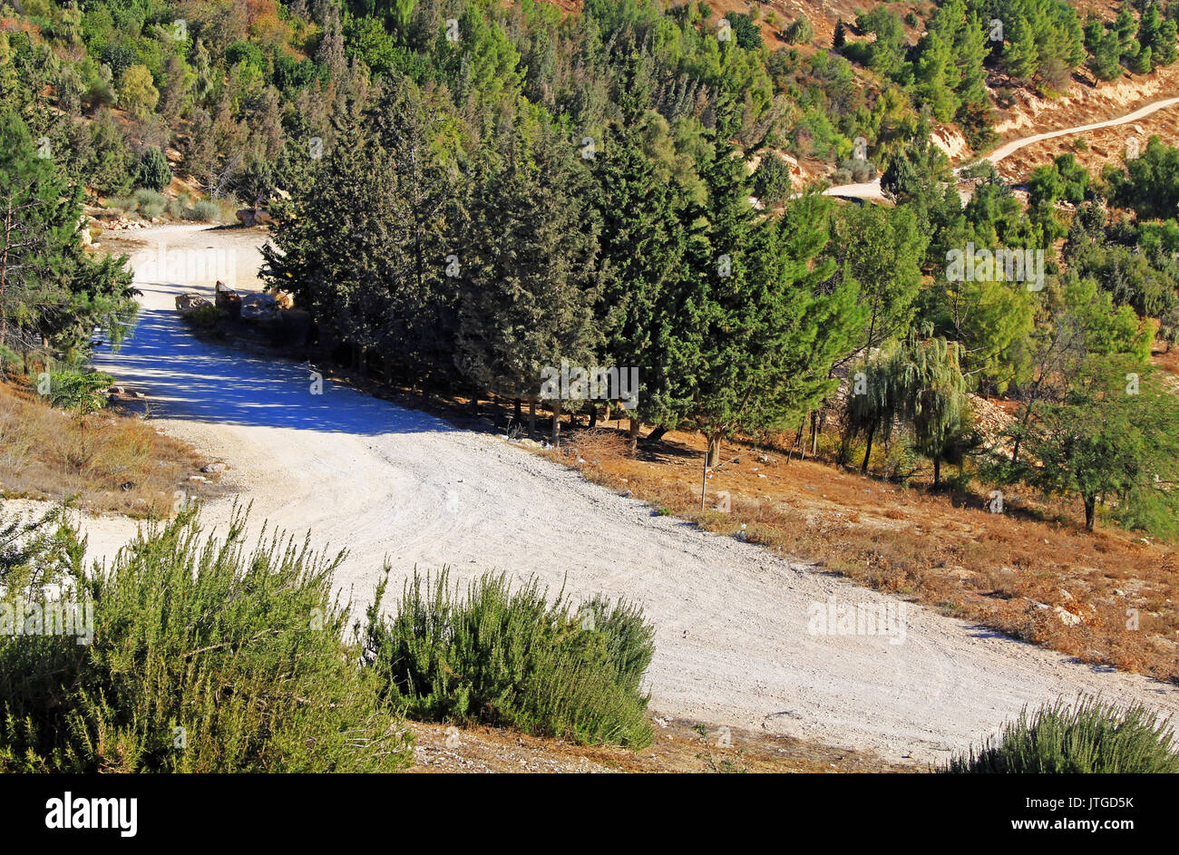 Rocky dirt road winding beside the Judean desert wilderness as seen ...