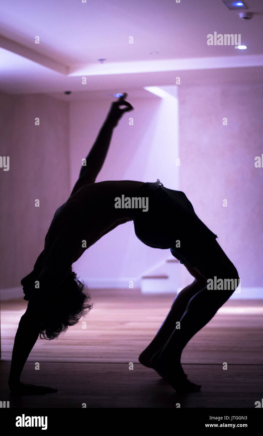 Yoga teacher doing backbend bridge flexibility and strength asana ...