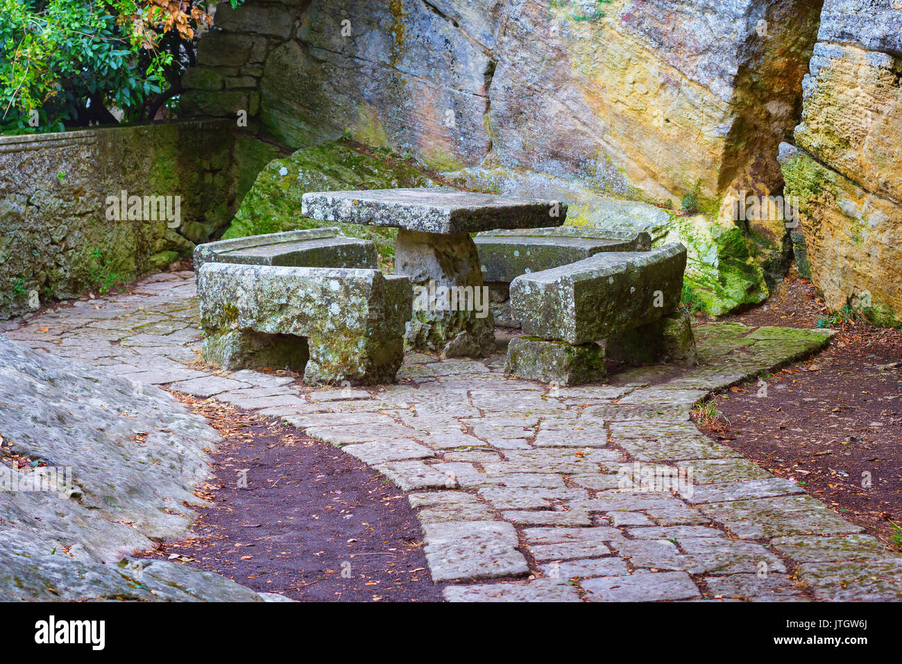 Stone arbor consisting of table and benches, silent place anyone can ...