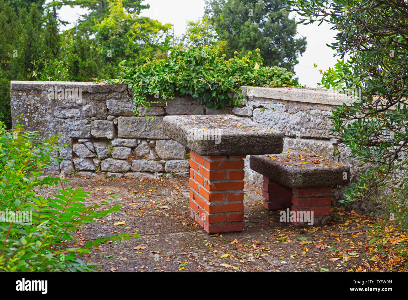 Stone arbor consisting of table and a bench, silent place anyone can ...
