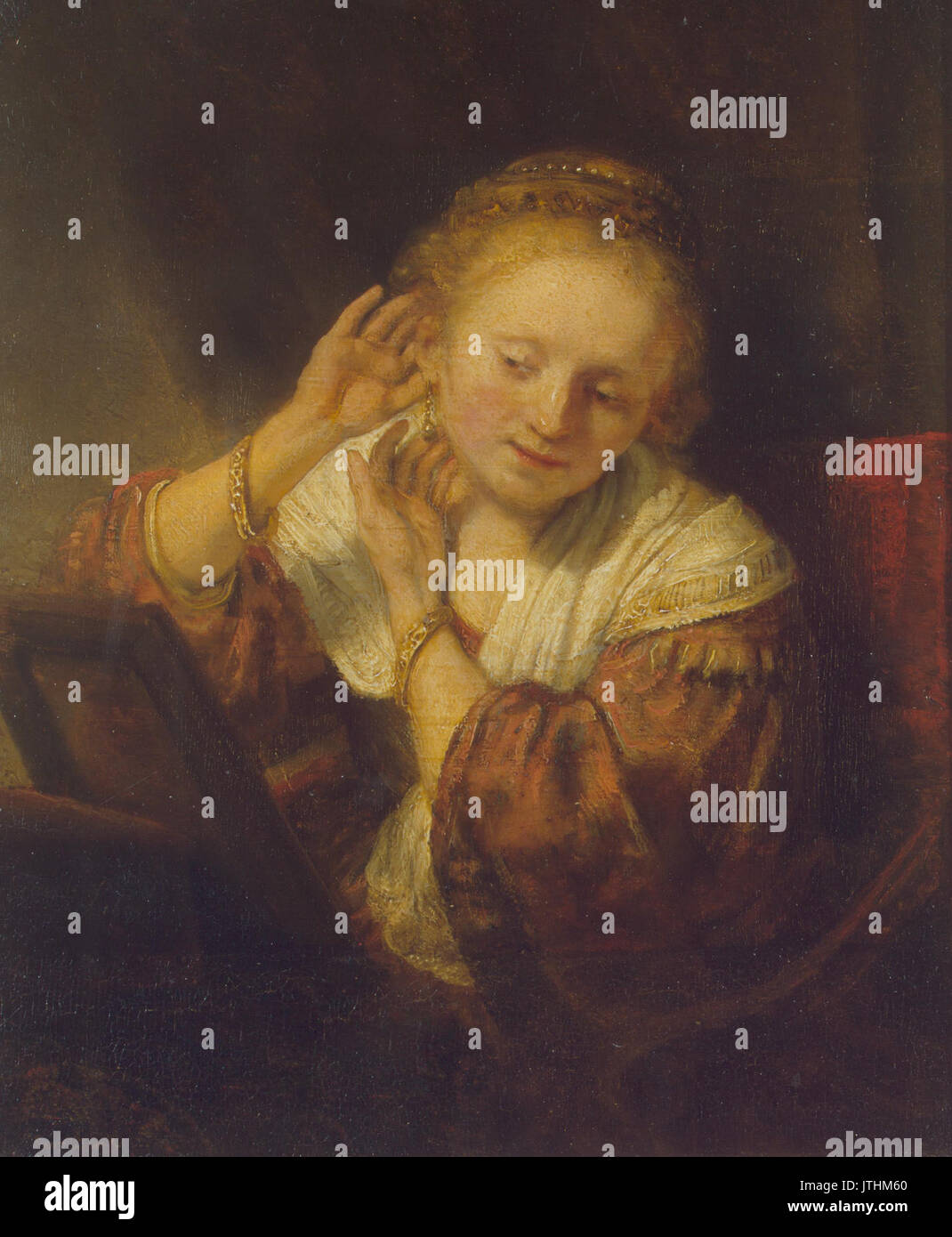 A renowned painting by Rembrandt, depicting a woman holding a mirror ...