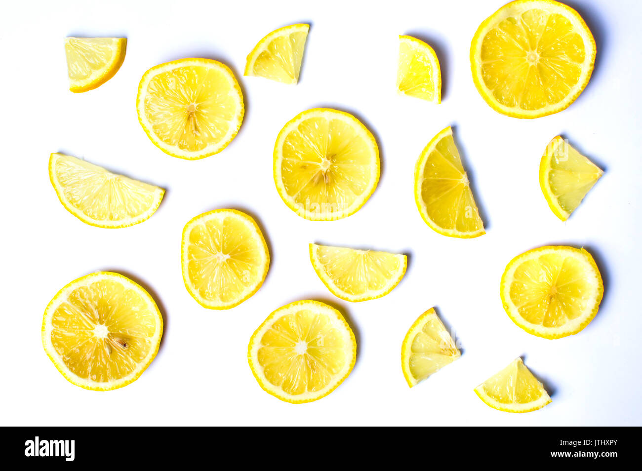 Lemon round and triangle slices on white background Stock Photo - Alamy