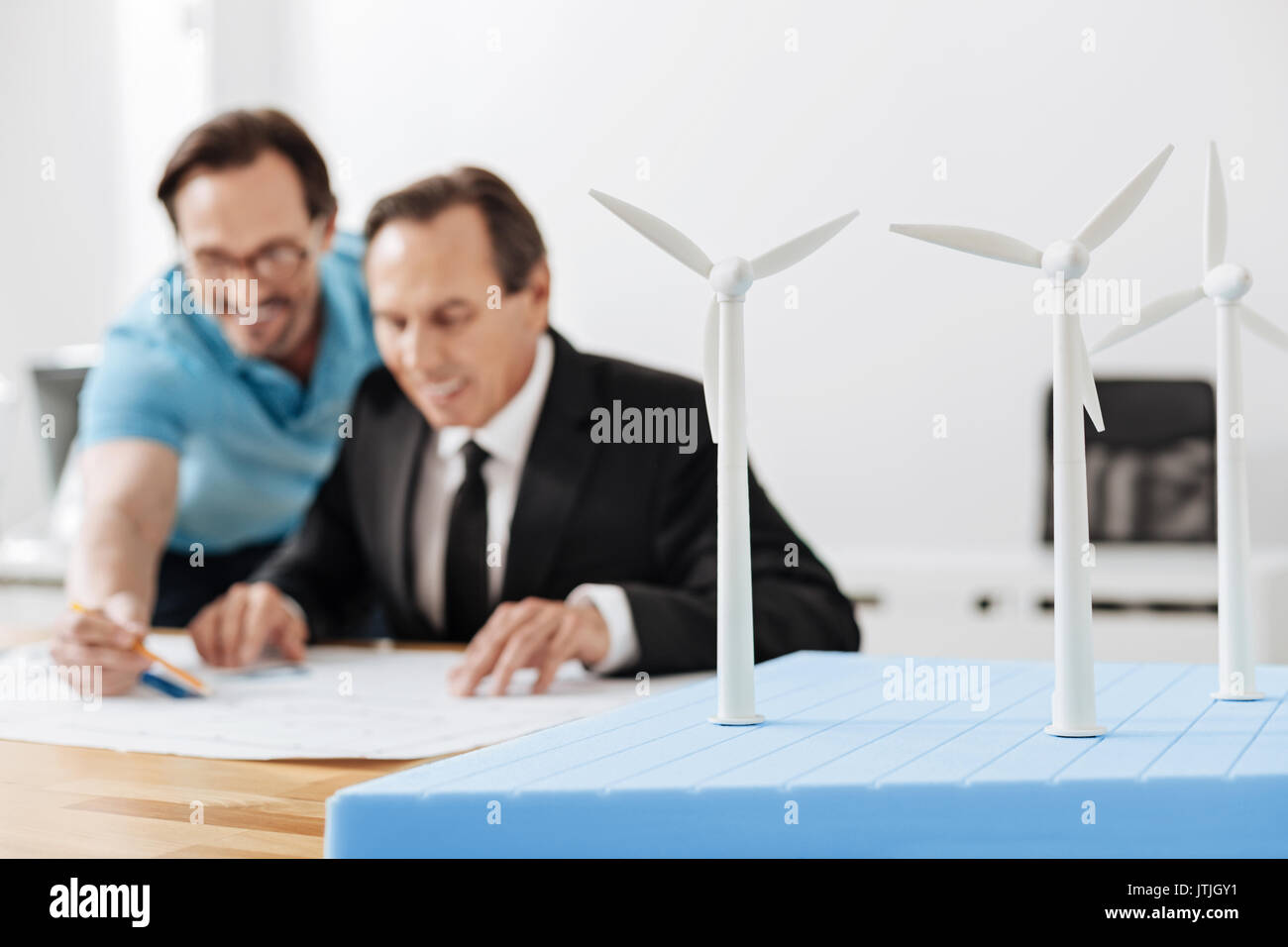 Engineer explaining important detail in the blueprint to colleague ...