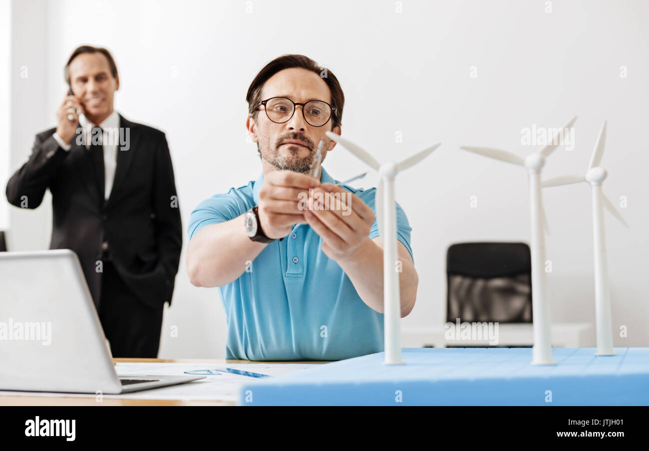 Diligent engineer measuring wind turbine sail length with compass Stock ...