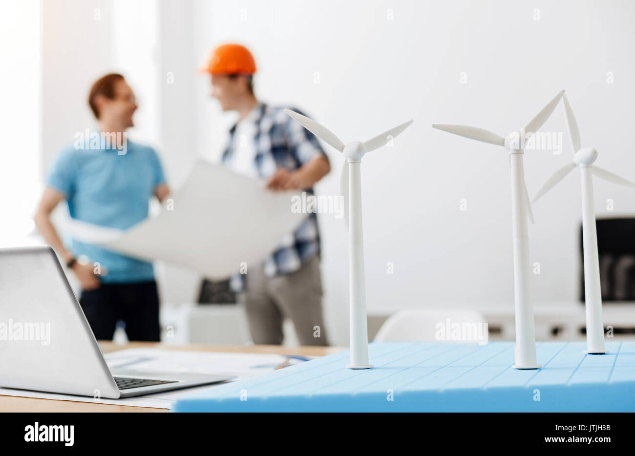 Engineer discussing a power station blueprint with a builder Stock ...